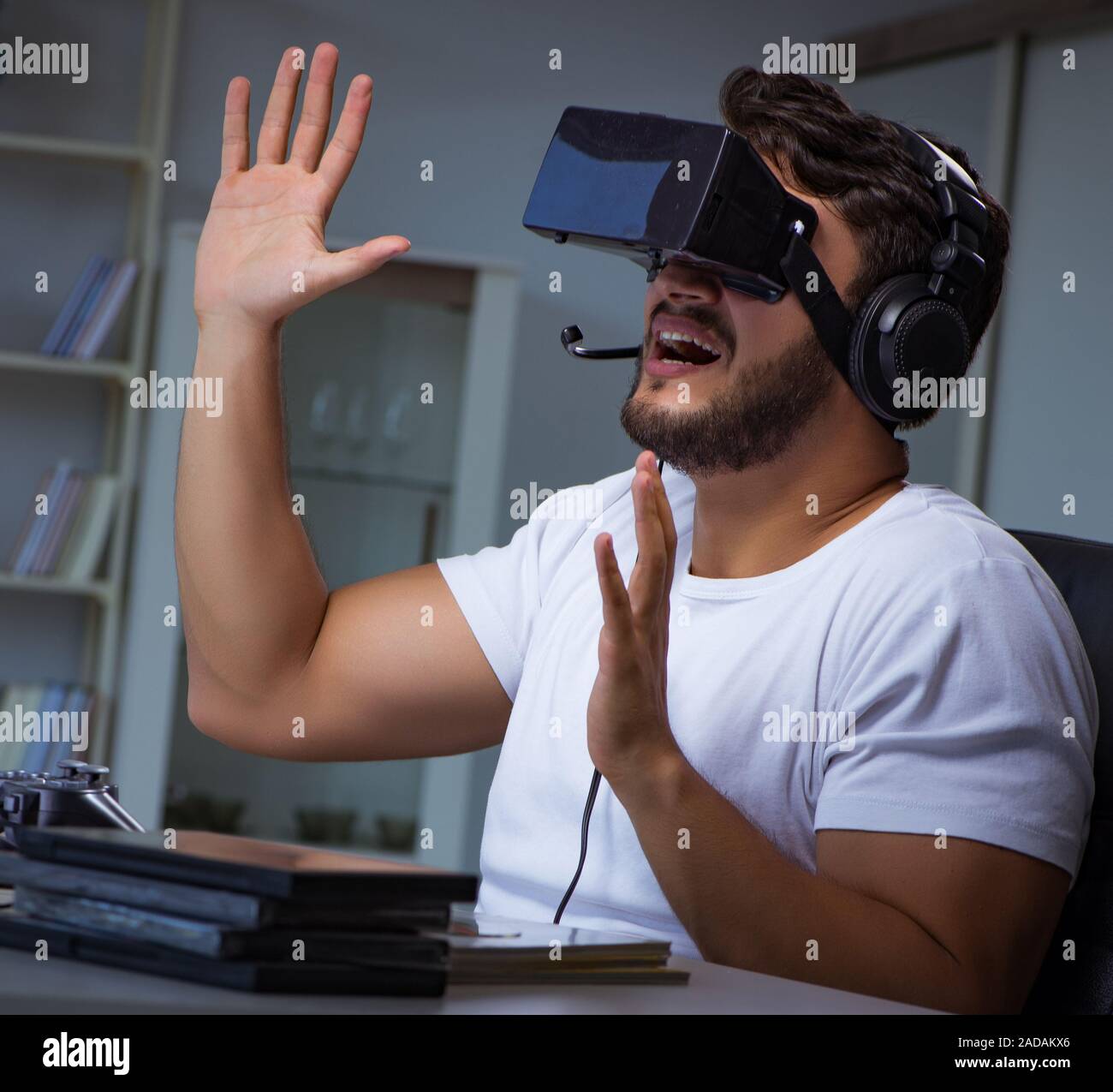 Young man playing games long hours late in the office Stock Photo - Alamy