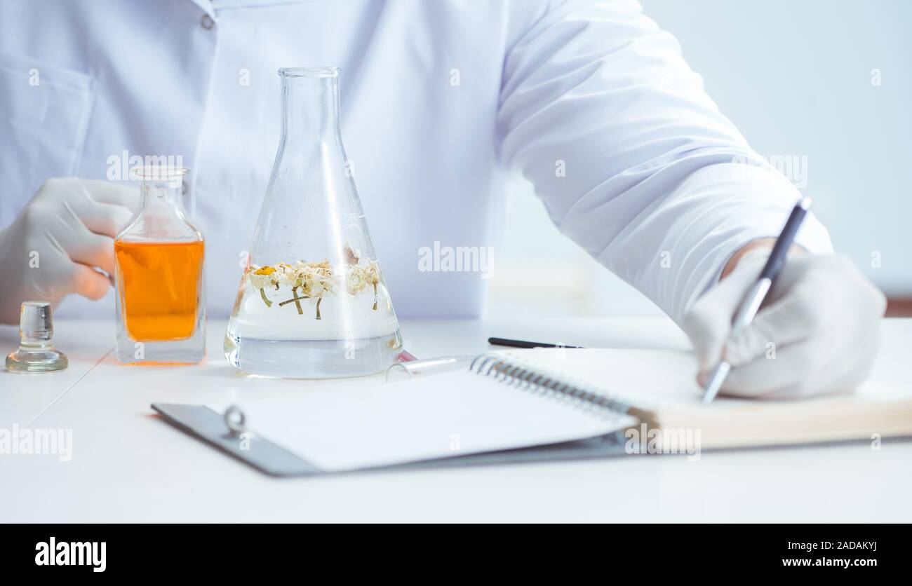 Chemist mixing perfumes in the lab Stock Photo - Alamy