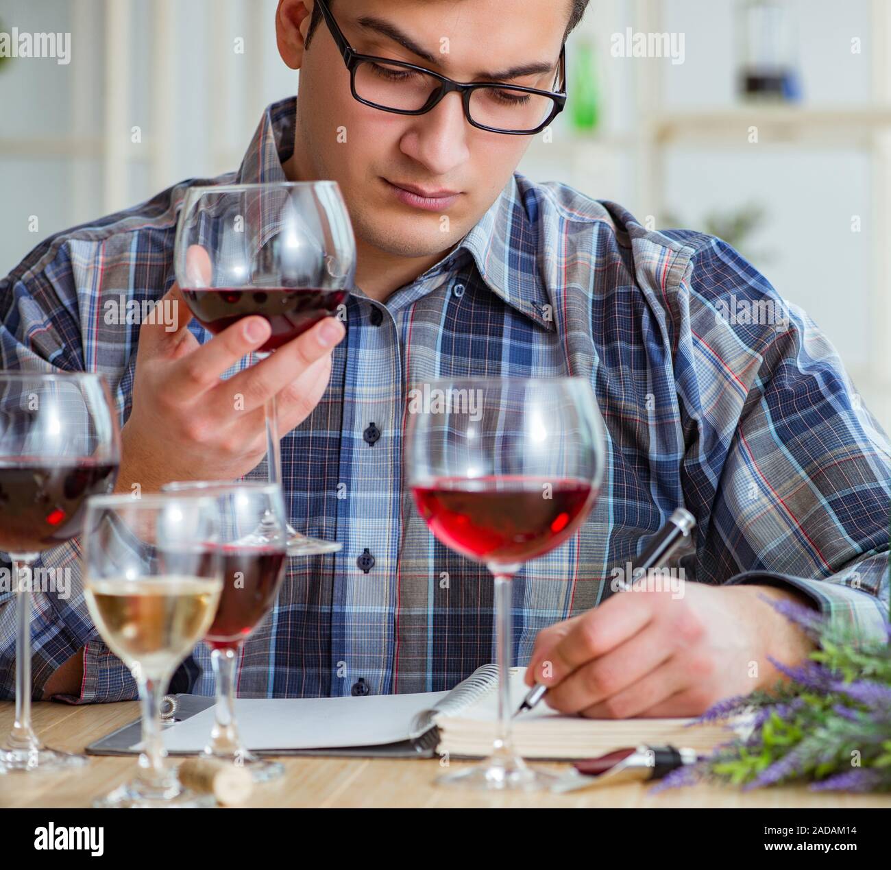 Professional sommelier tasting red wine Stock Photo - Alamy