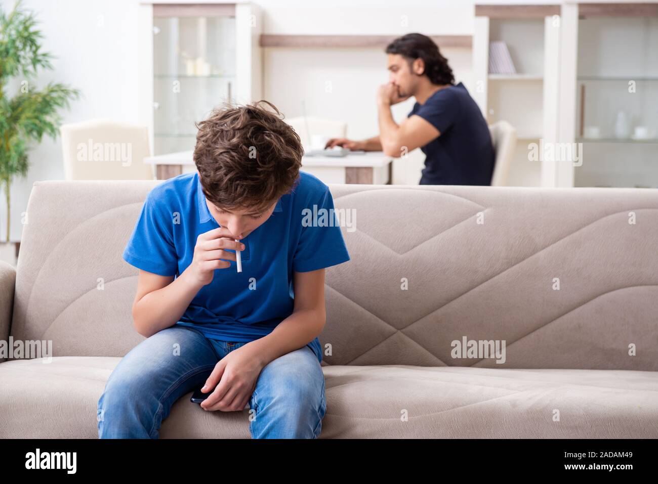 Concept of underage smoking with young boy and family Stock Photo - Alamy