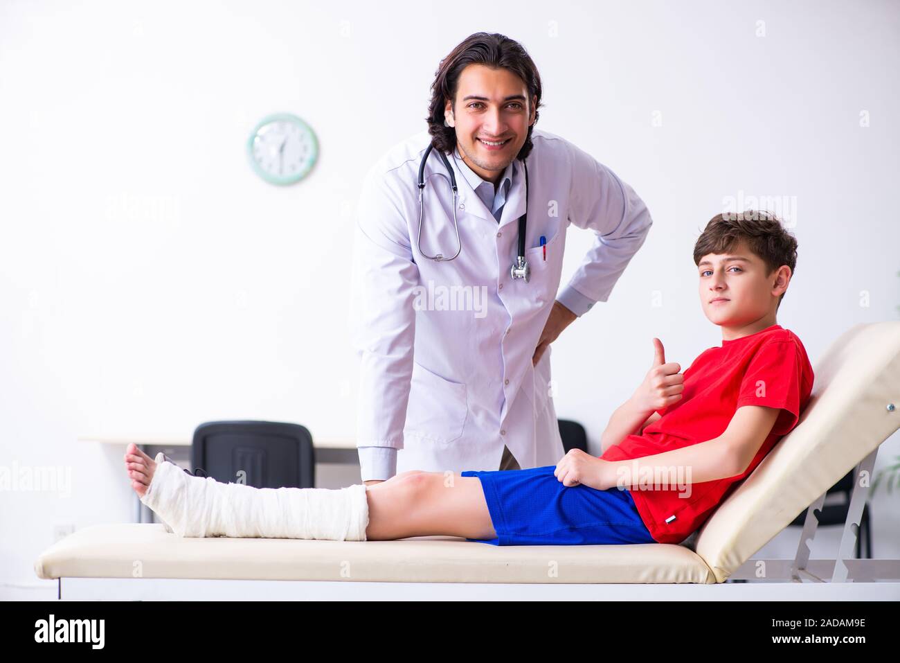 Leg injured boy visiting young doctor traumatologist Stock Photo - Alamy