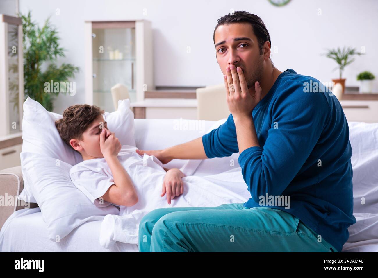 Young father caring for sick son Stock Photo - Alamy