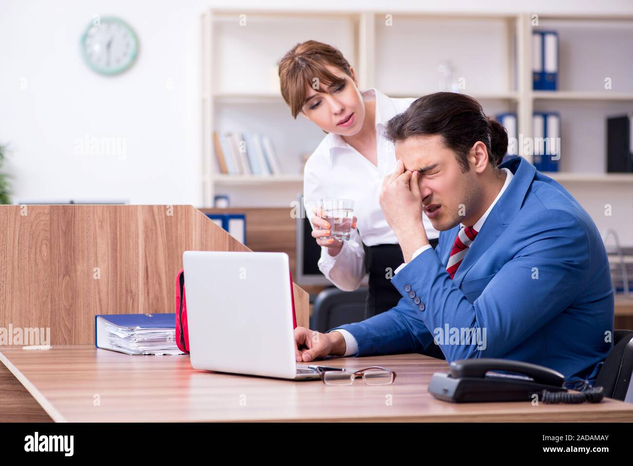 Young employee suffering in the office Stock Photo - Alamy