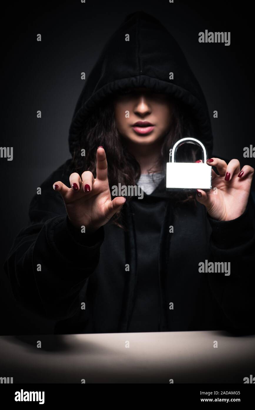 Female hacker hacking security firewall late in office Stock Photo - Alamy