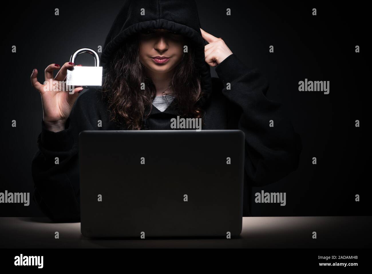 Female hacker hacking security firewall late in office Stock Photo - Alamy