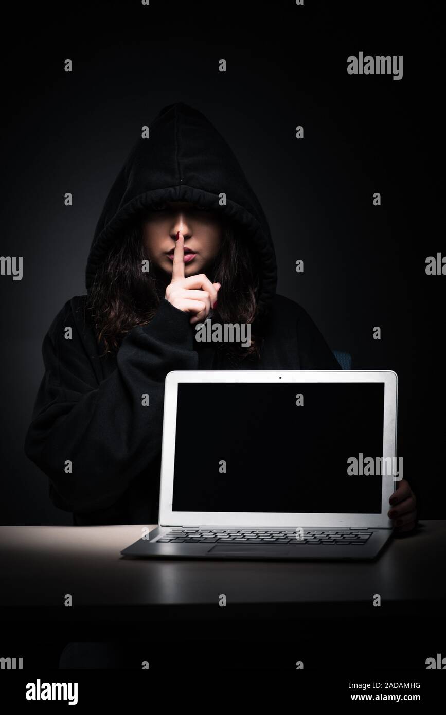 Female hacker hacking security firewall late in office Stock Photo - Alamy