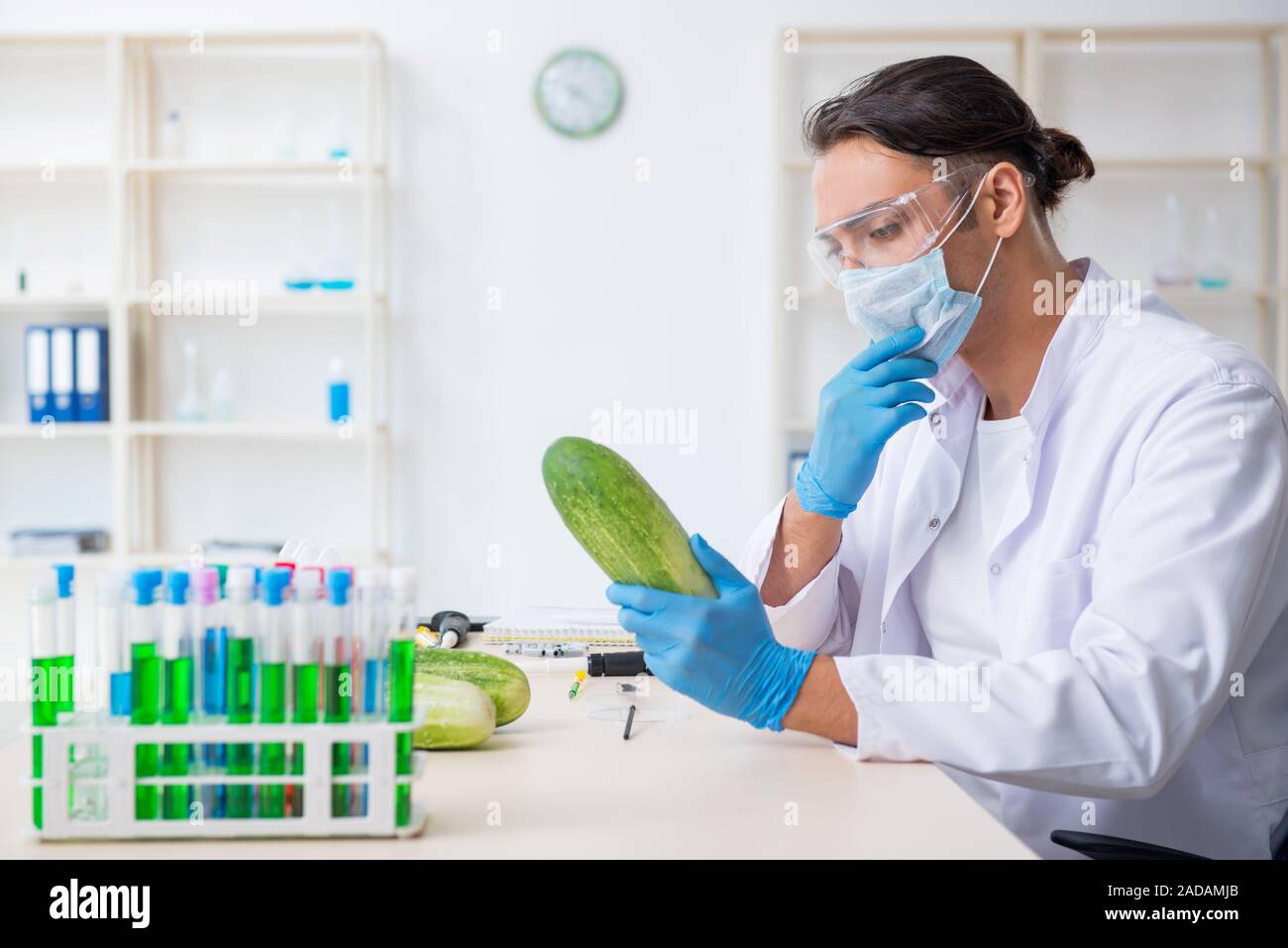 Male nutrition expert testing vegetables in lab Stock Photo - Alamy