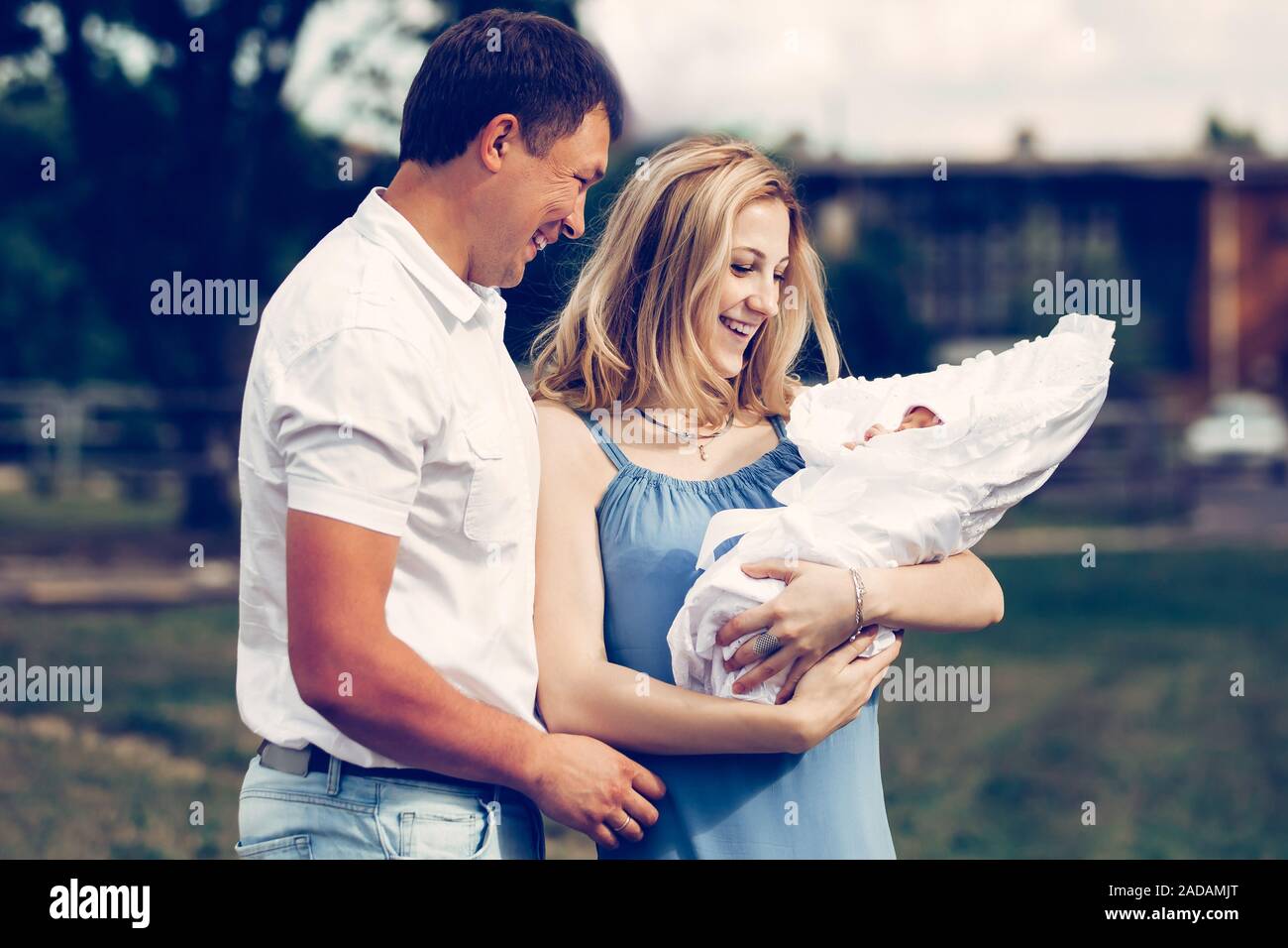 happy married couple looking at their newborn baby . the concept of ...