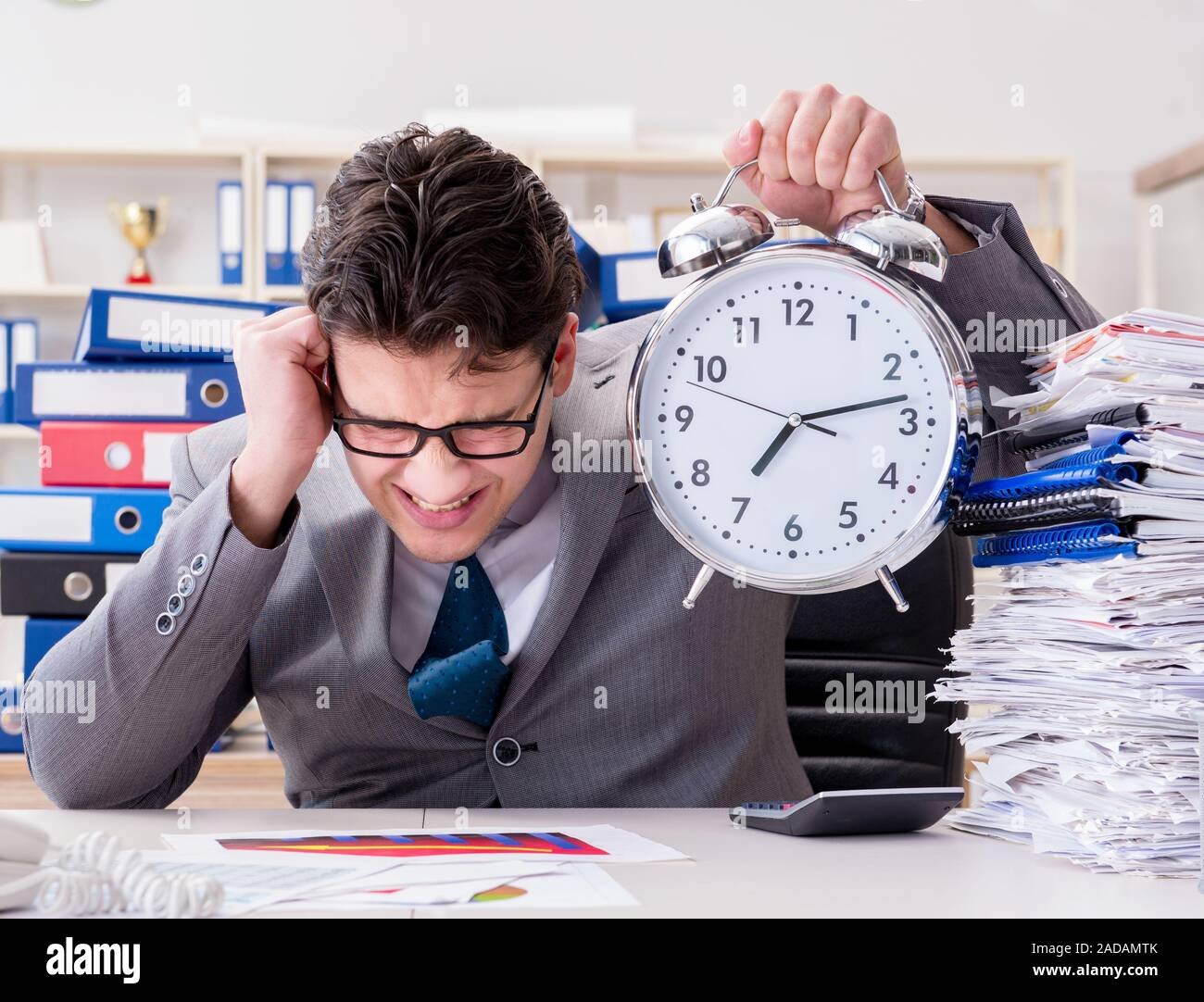 Businessman missing deadlines due to excessive work Stock Photo - Alamy