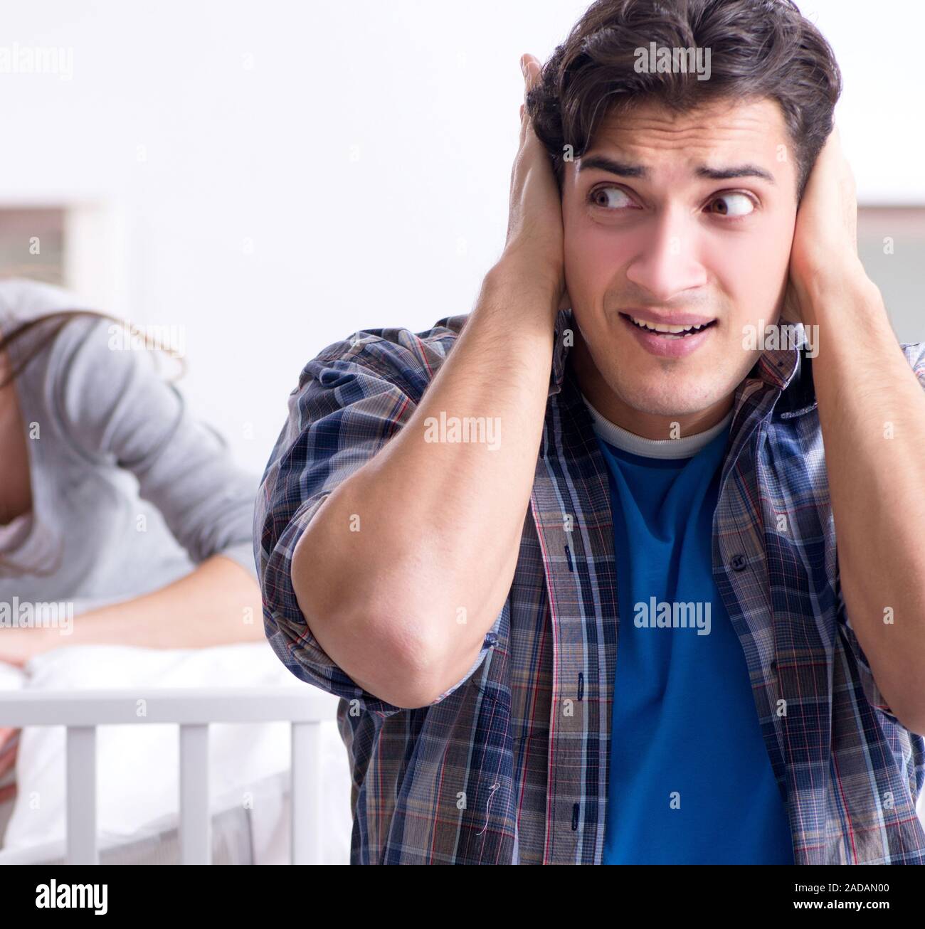 Young dad cannot stand baby crying Stock Photo - Alamy