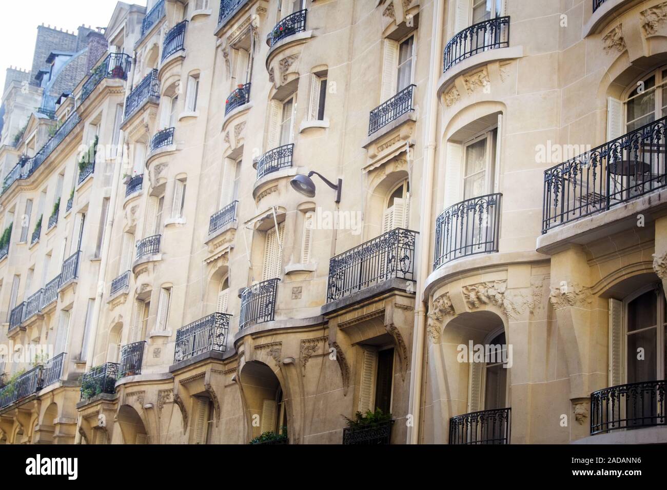 Paris old building with straight and round balconies, awnings, stucco ...