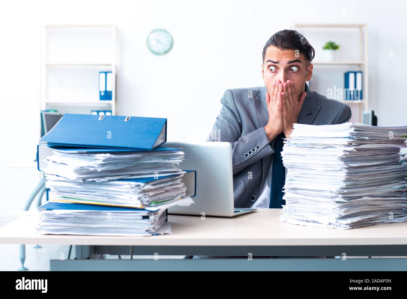 Businessman with heavy paperwork workload Stock Photo - Alamy