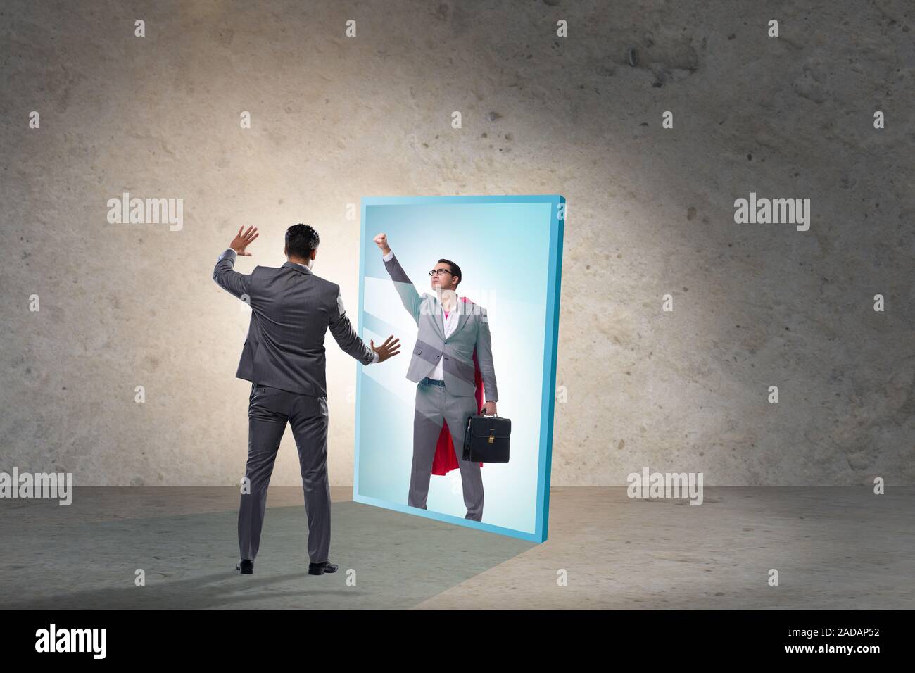 Businessman seeing himself in mirror as superhero Stock Photo - Alamy