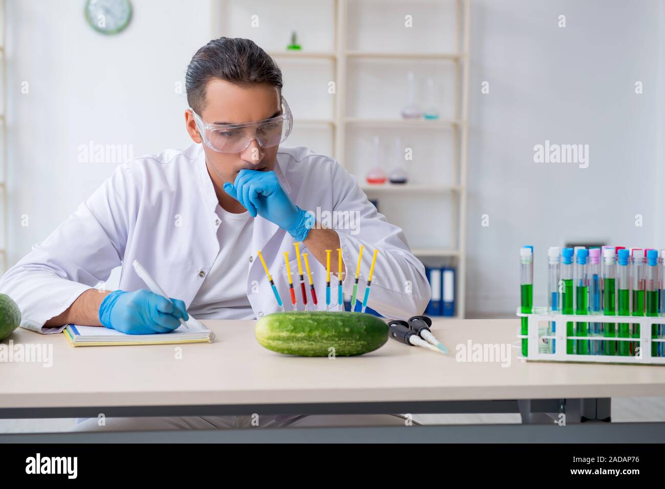 Male nutrition expert testing vegetables in lab Stock Photo - Alamy