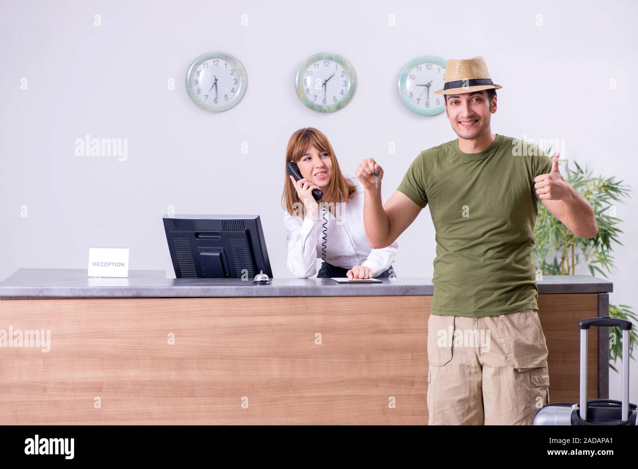 Hotel receptionist giving out key hi-res stock photography and images ...