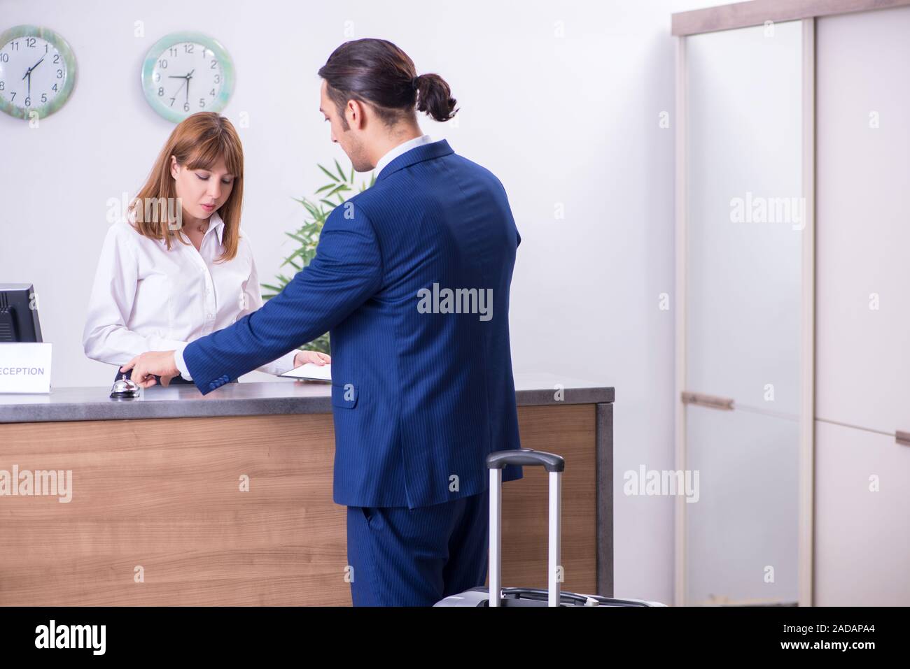 Young businessman at hotel reception Stock Photo - Alamy