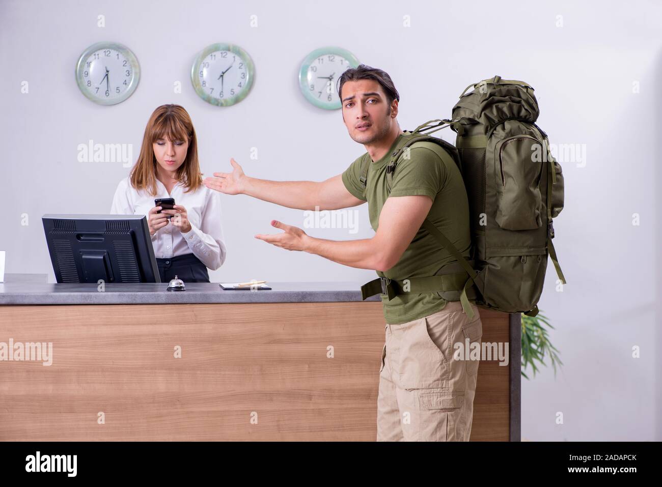 Young man at the hotel reception Stock Photo - Alamy