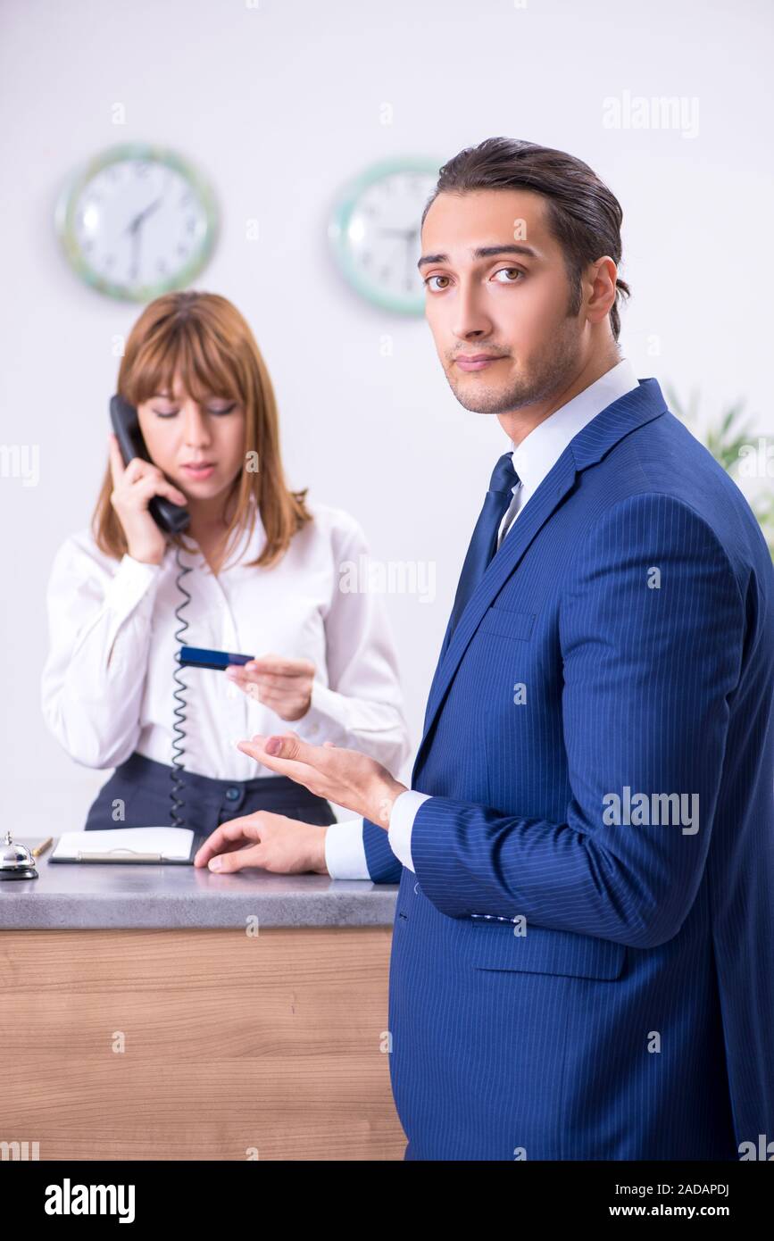Young businessman at hotel reception Stock Photo - Alamy