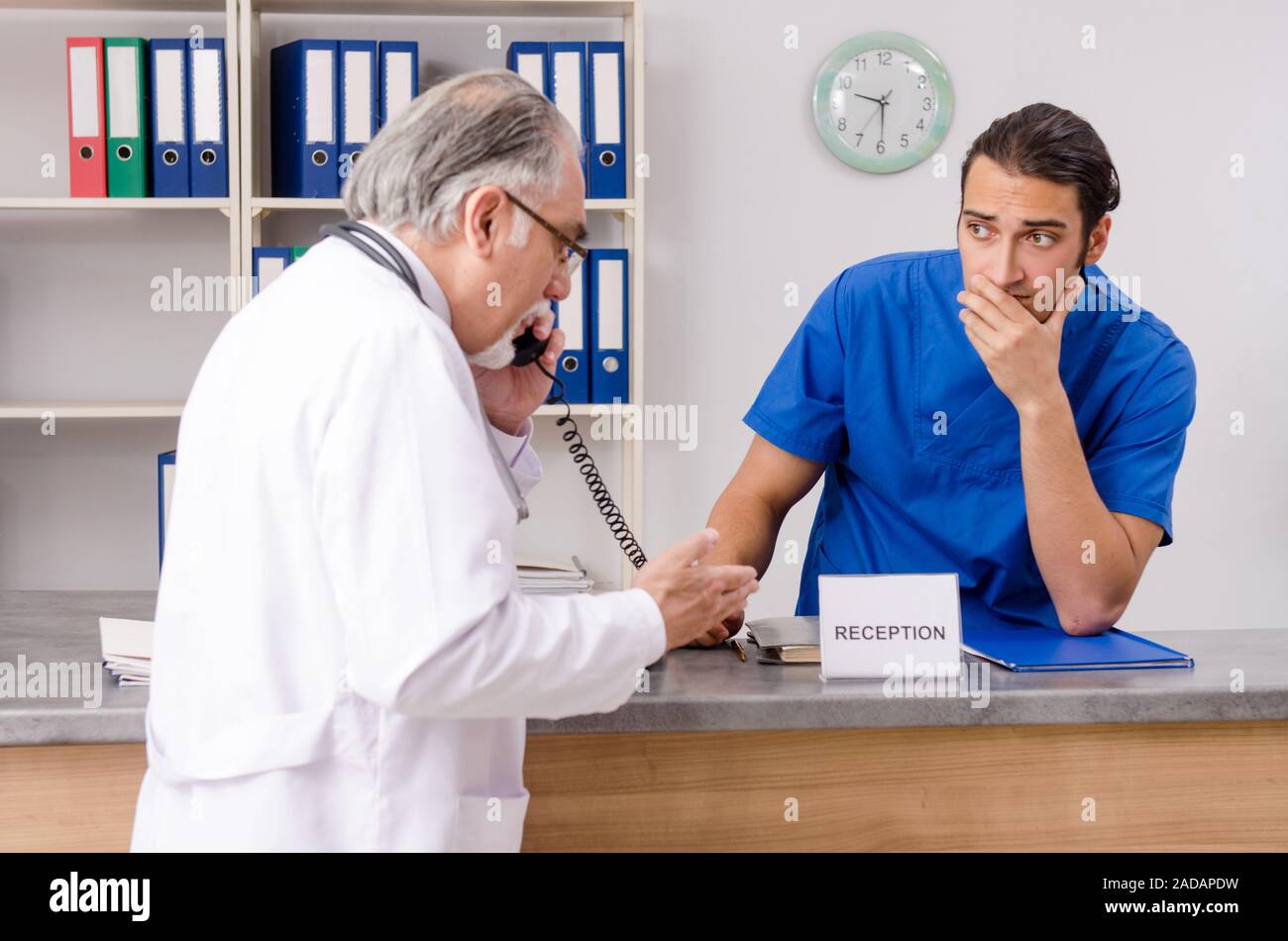 Two doctors talking at the reception in hospital Stock Photo - Alamy