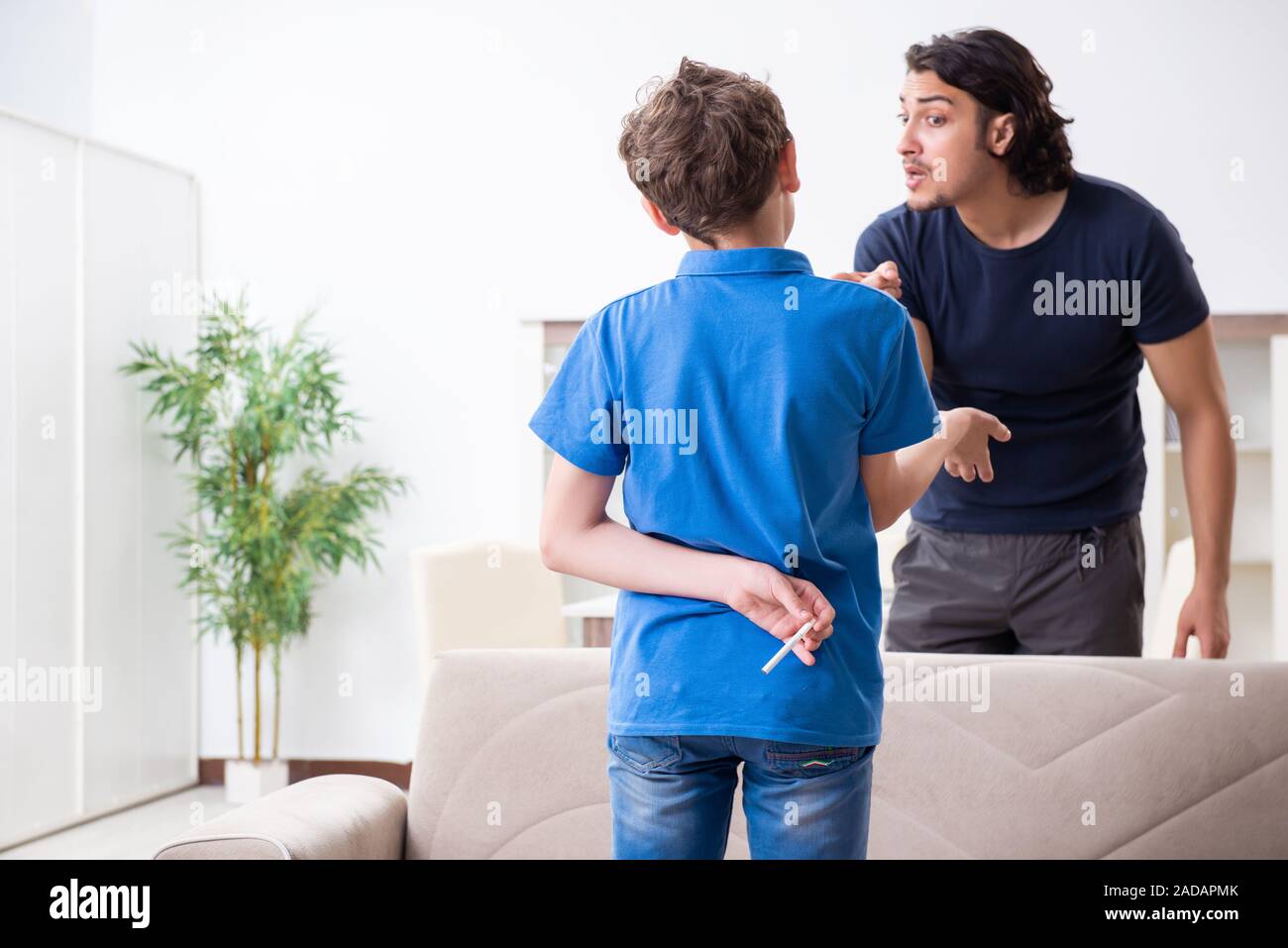 Concept of underage smoking with young boy and family Stock Photo - Alamy