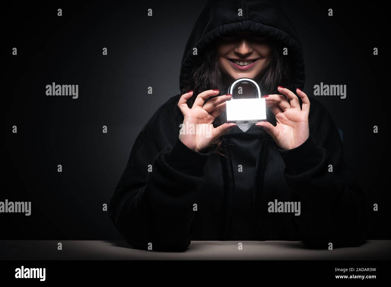 Female hacker hacking security firewall late in office Stock Photo - Alamy