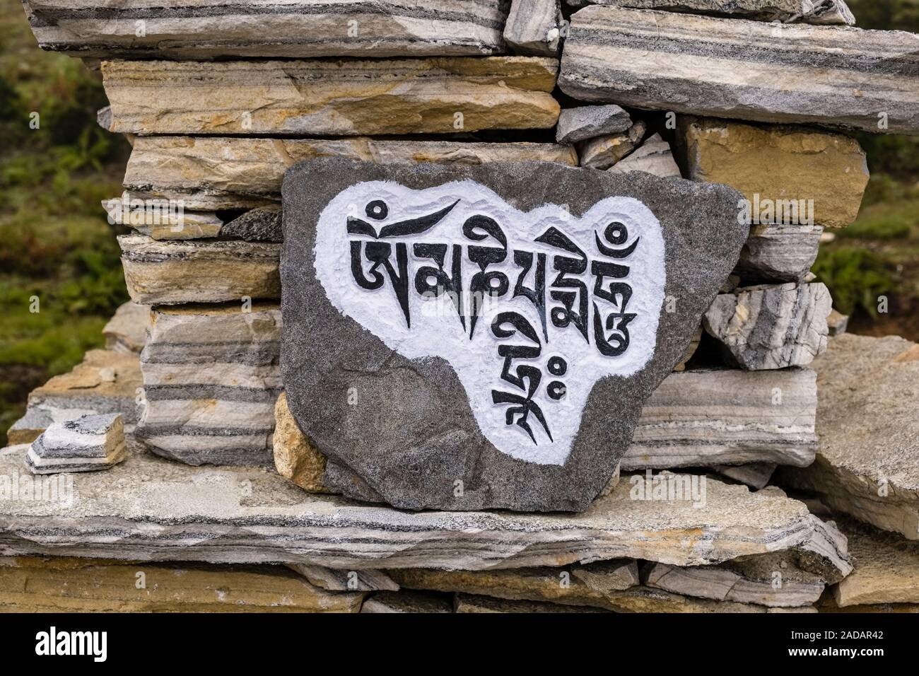 Mani Stone with the engraved tibetan mantra Om Mani Padme hum, located ...