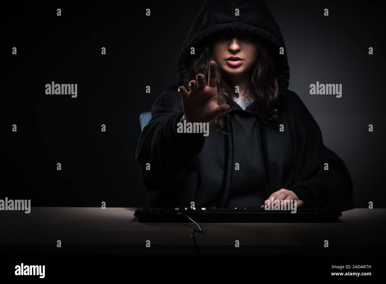 Female hacker hacking security firewall late in office Stock Photo - Alamy