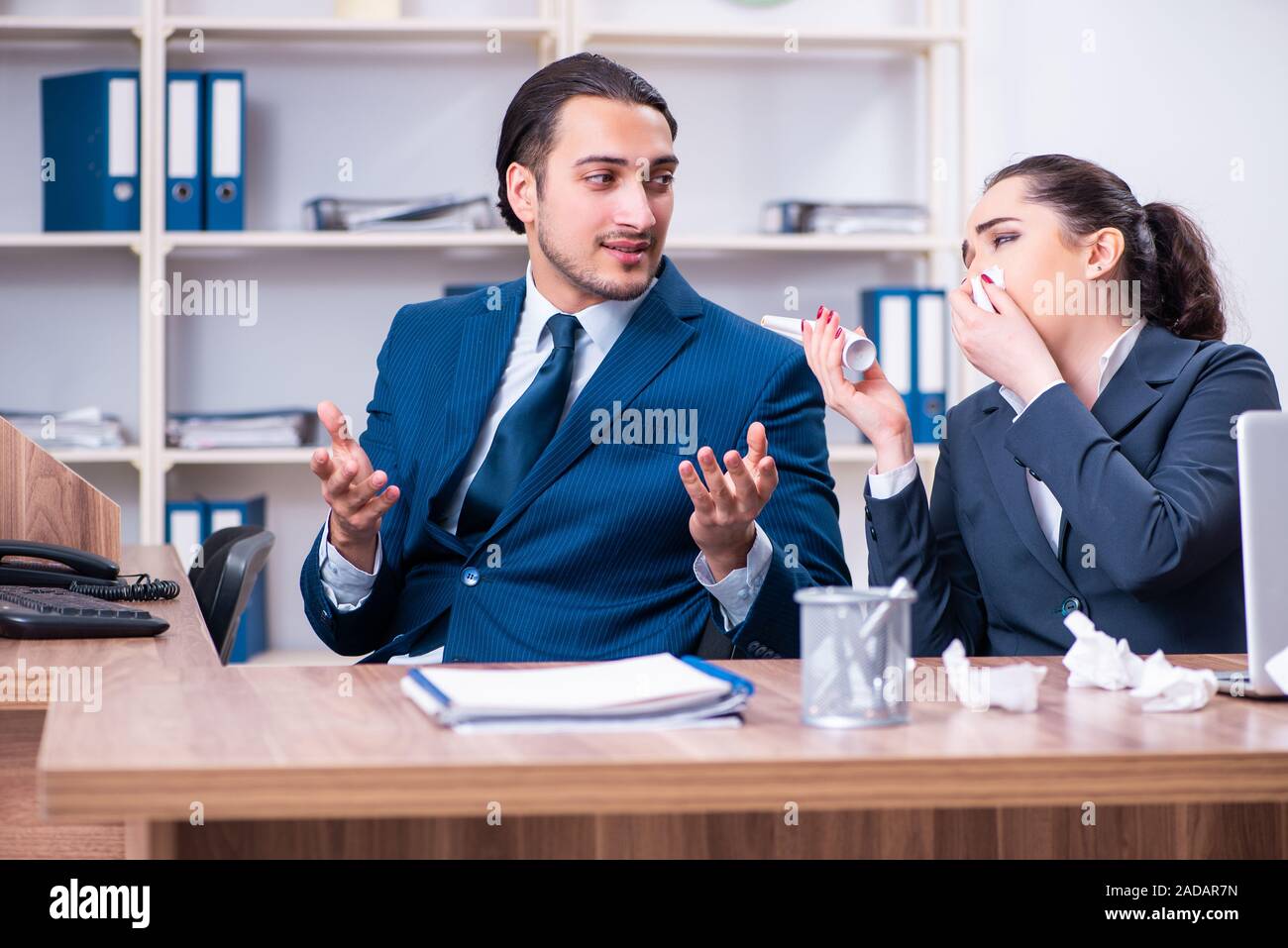 Two employees suffering at workplace Stock Photo - Alamy