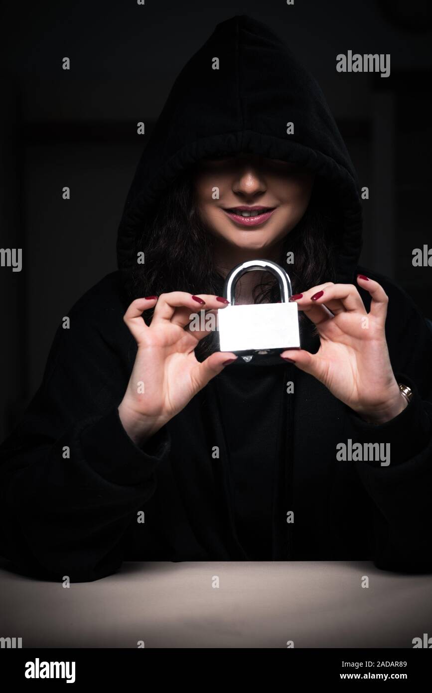 Female hacker hacking security firewall late in office Stock Photo - Alamy