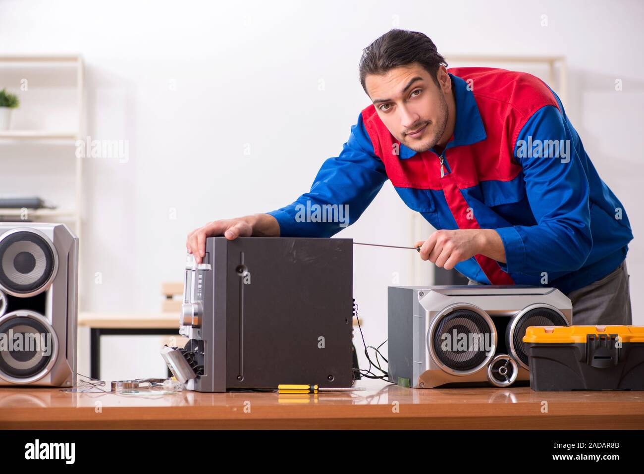 Young engineer repairing musical hi-fi system Stock Photo - Alamy