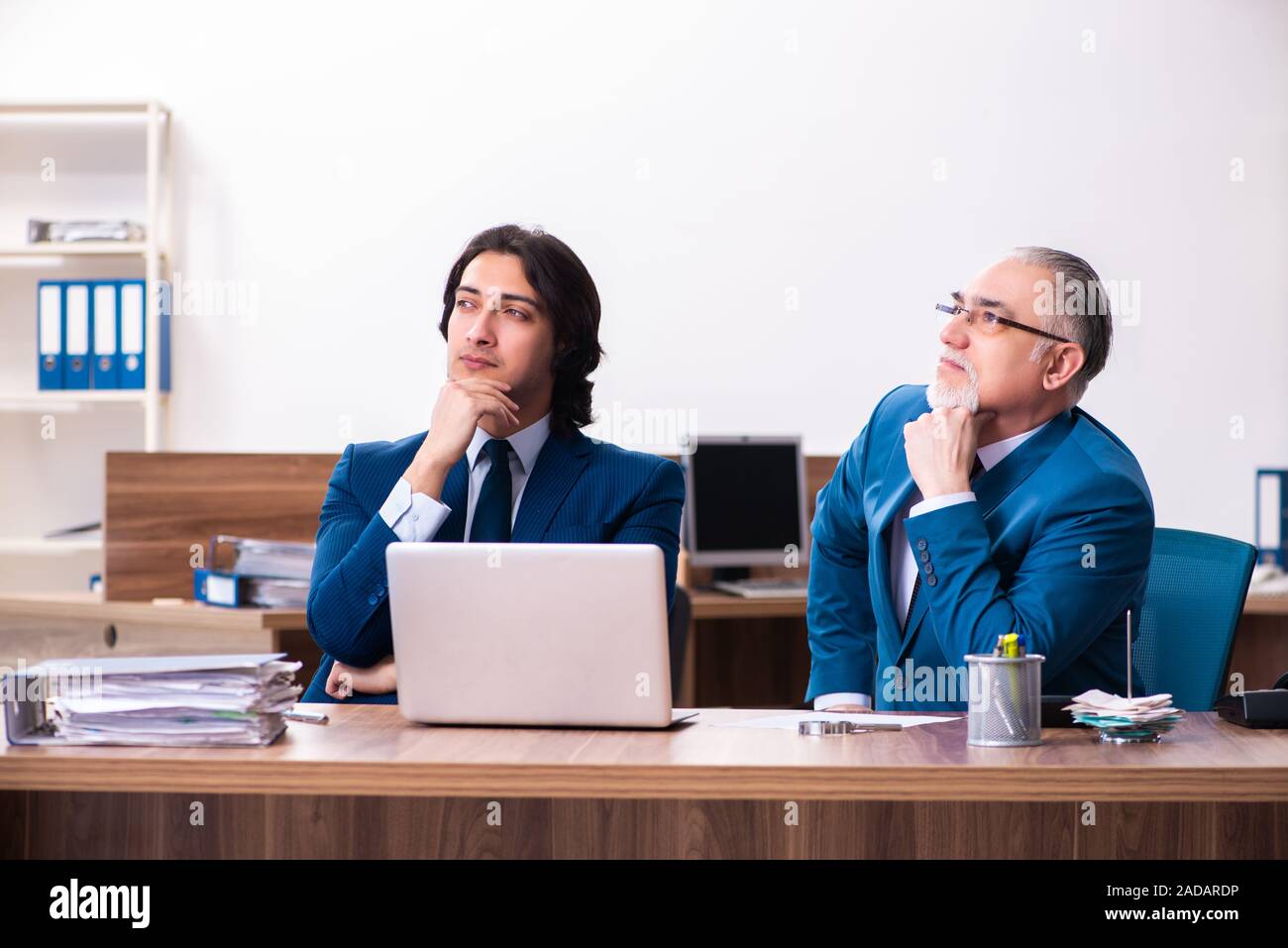 Young and old employees working together in the office Stock Photo - Alamy
