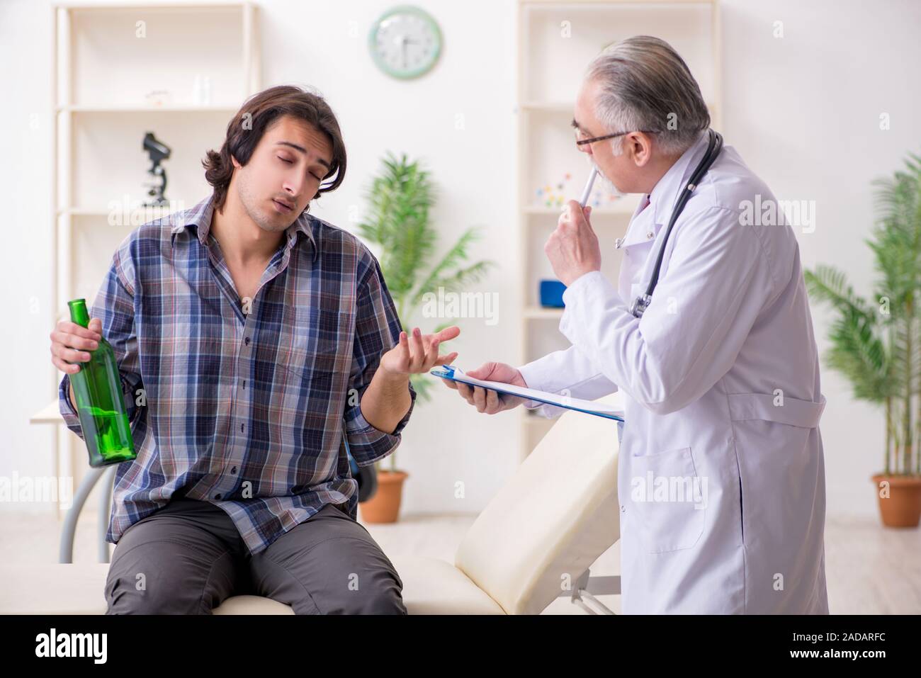 Young male alcoholic visiting old doctor Stock Photo - Alamy
