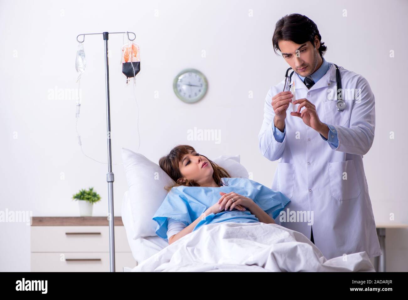 Male doctor visiting female hi-res stock photography and images - Alamy