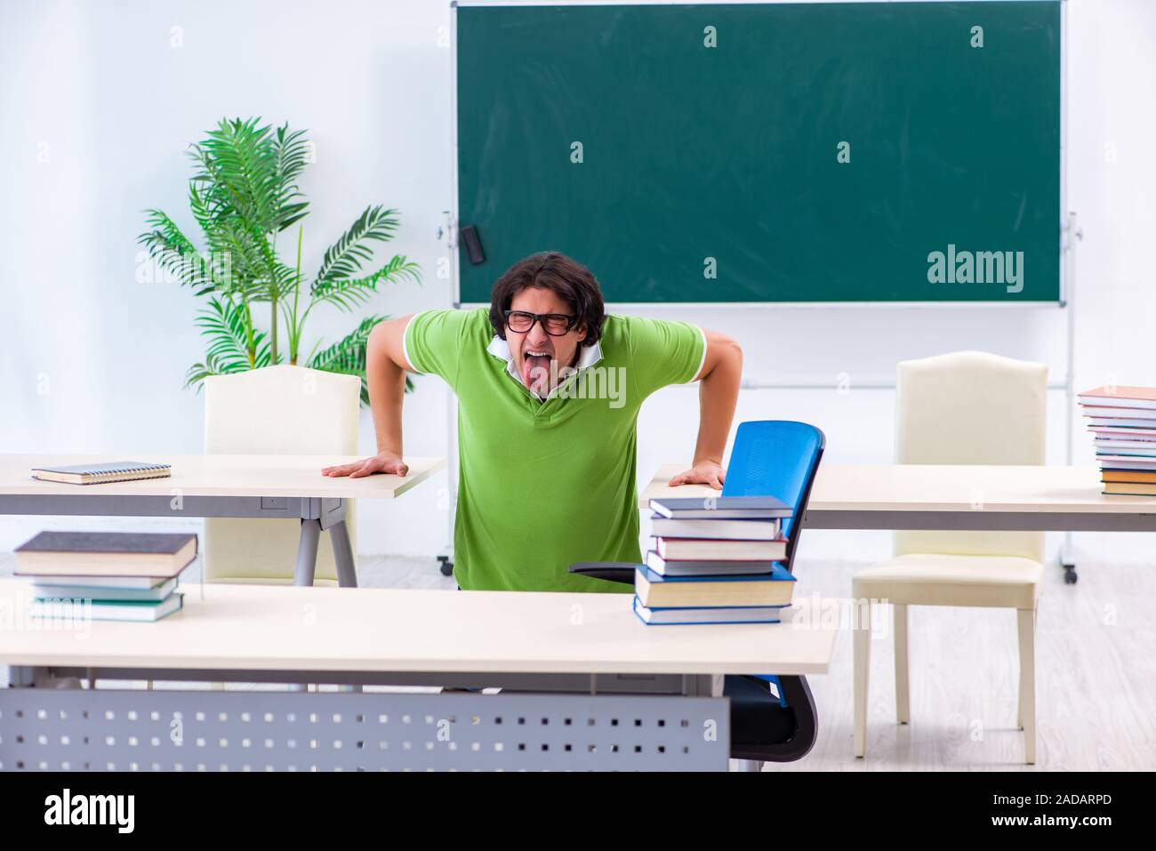 Young student doing physical exercises in the classroom Stock Photo - Alamy