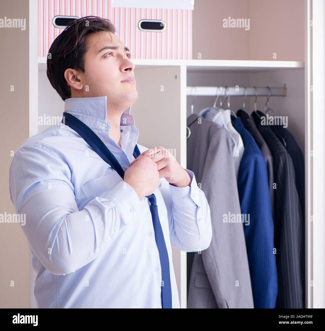 Young man Businessman getting dressed for work Stock Photo - Alamy