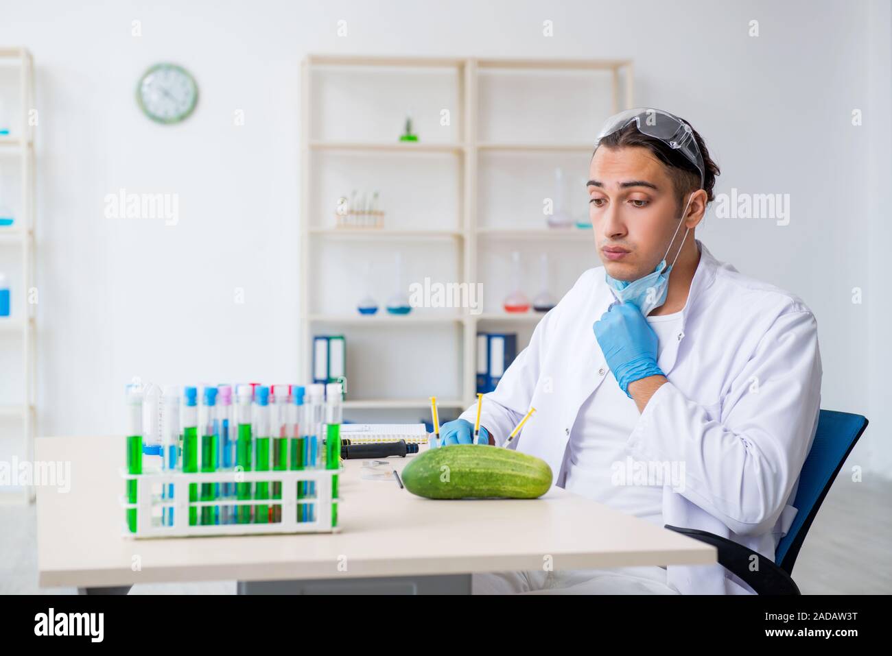 Male nutrition expert testing vegetables in lab Stock Photo - Alamy