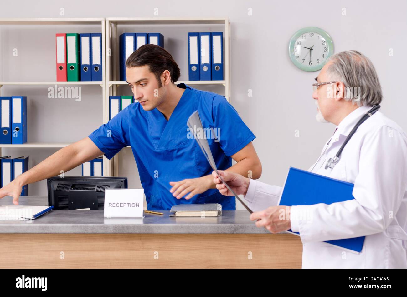 Two doctors talking at the reception in hospital Stock Photo - Alamy