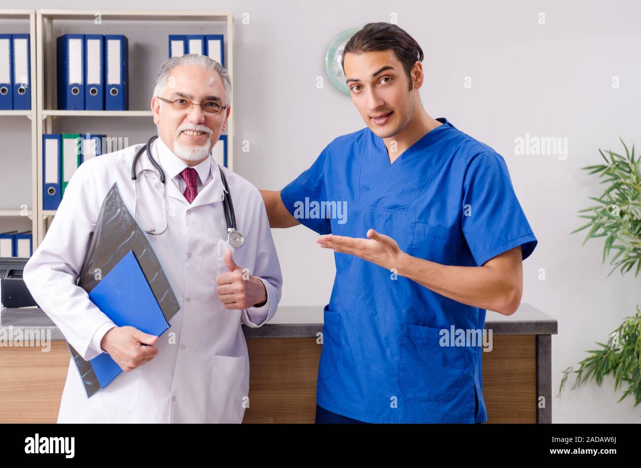 Two doctors talking at the reception in hospital Stock Photo - Alamy