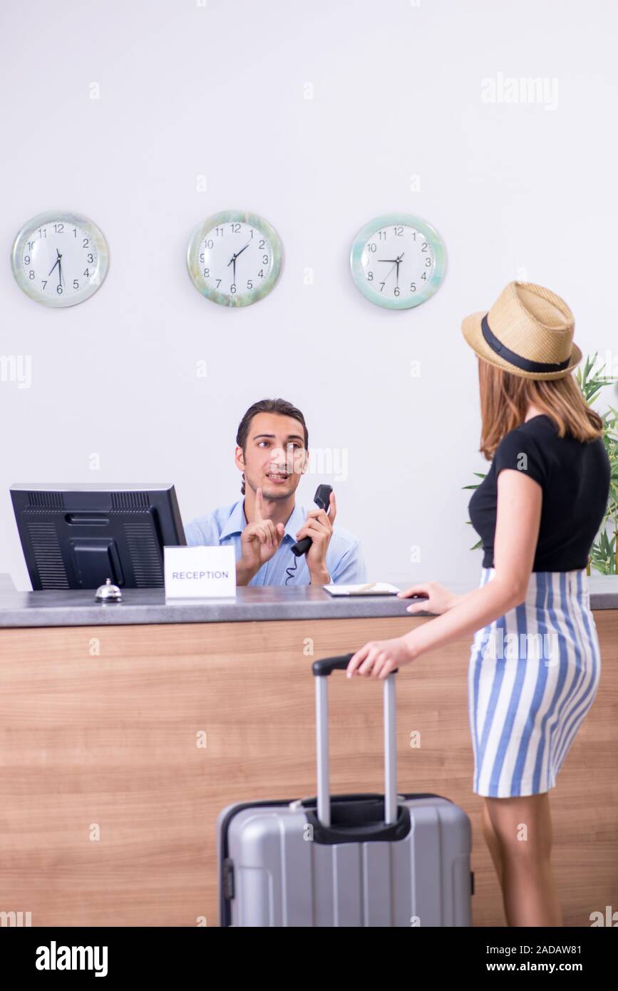 Young woman at hotel reception Stock Photo - Alamy