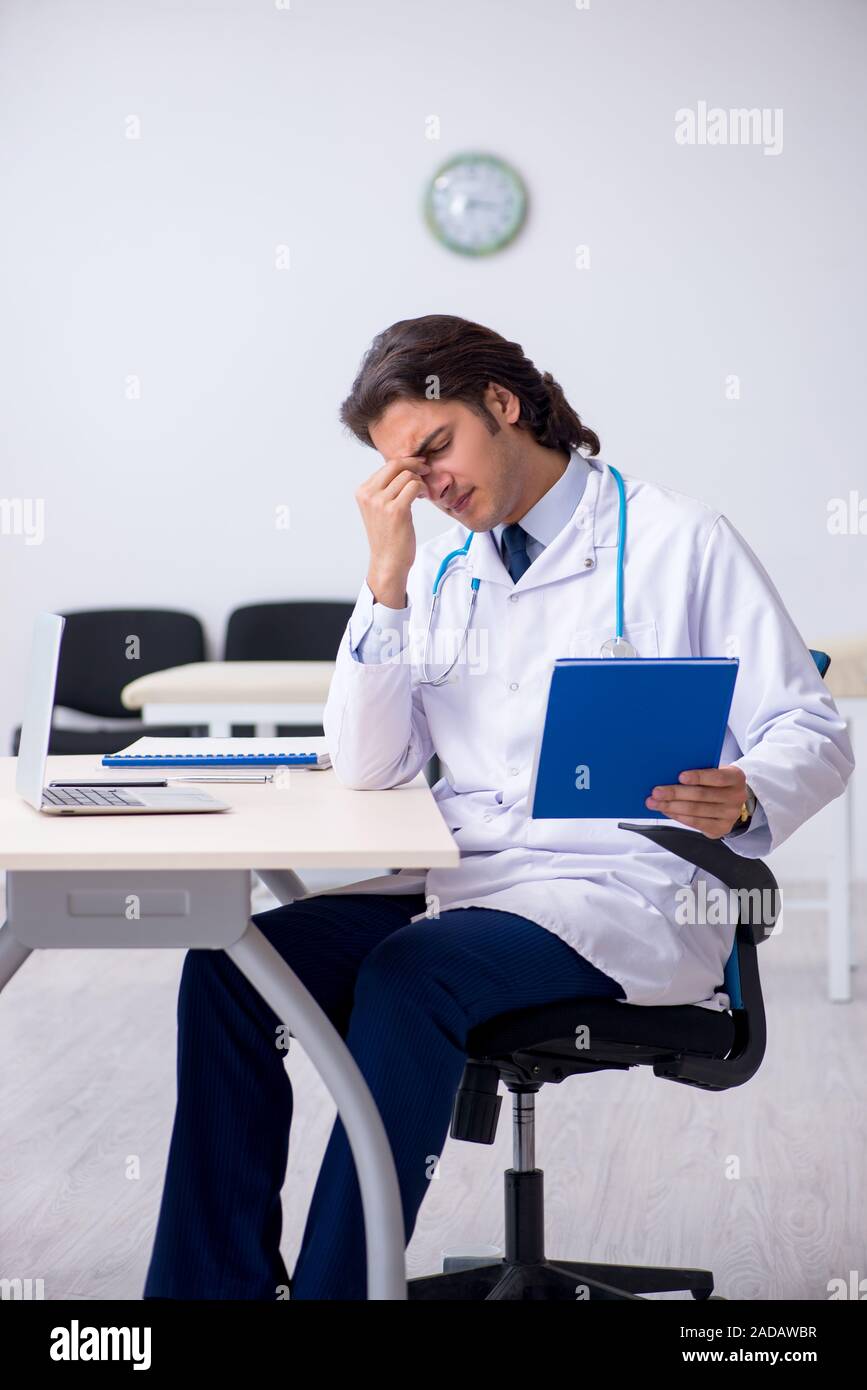 Young doctor being tired after night shift Stock Photo - Alamy