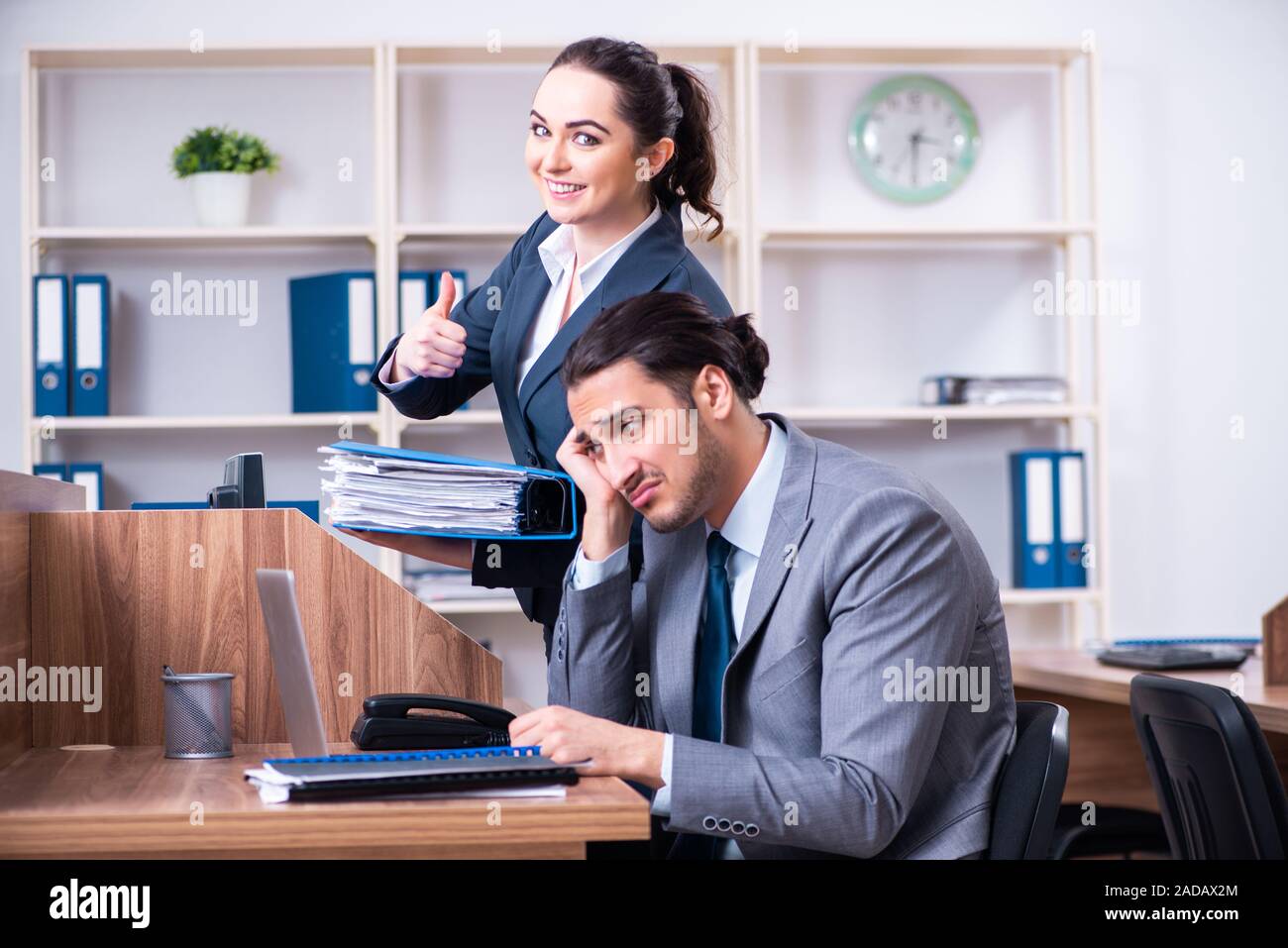 Two employees working in the office Stock Photo - Alamy