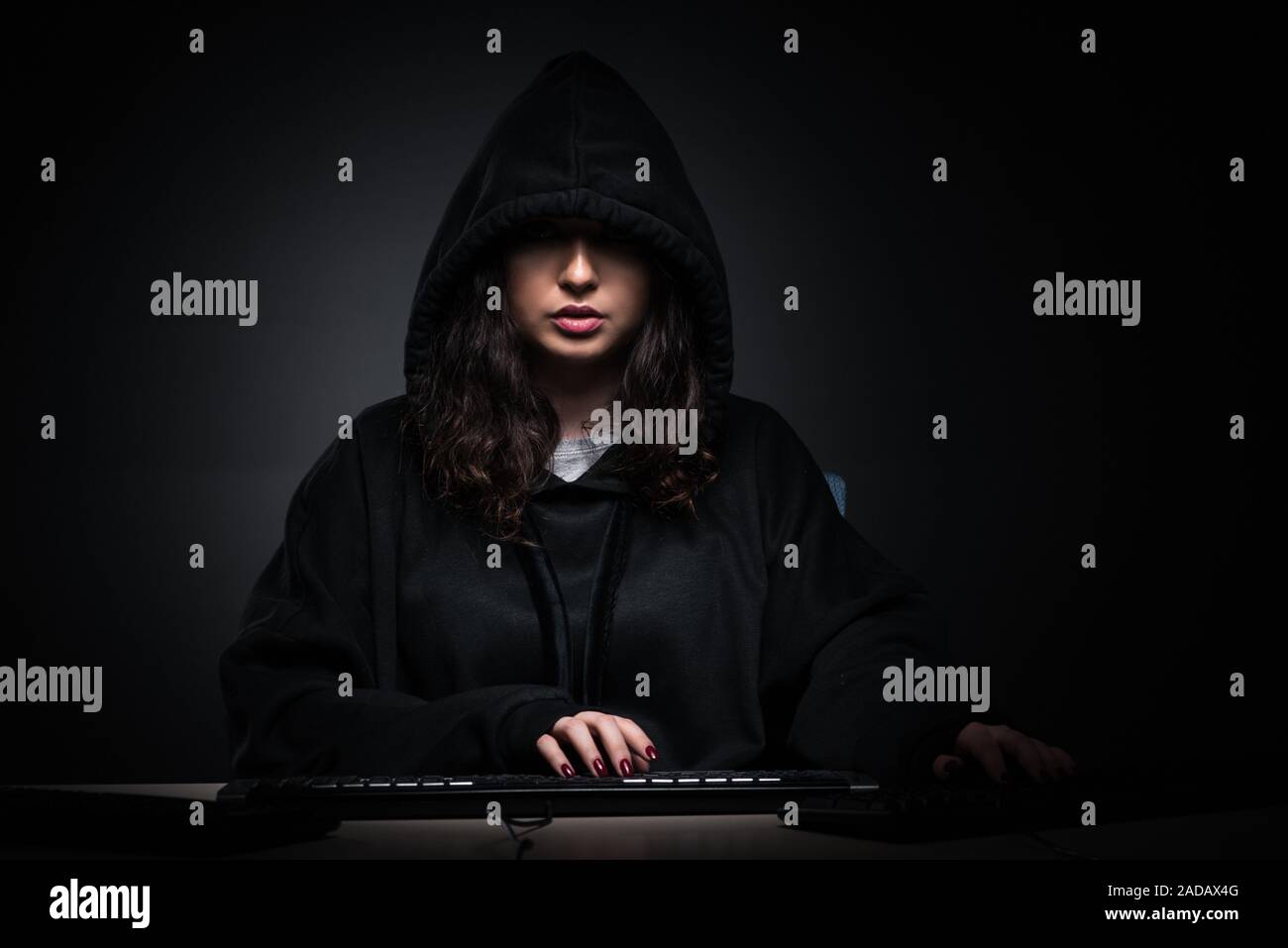 Female hacker hacking security firewall late in office Stock Photo - Alamy