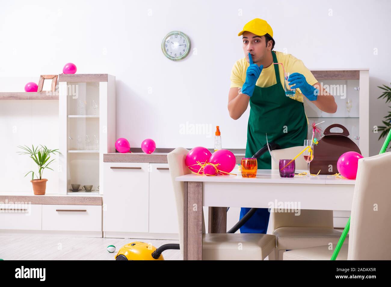 Young male contractor doing housework after party hi-res stock ...