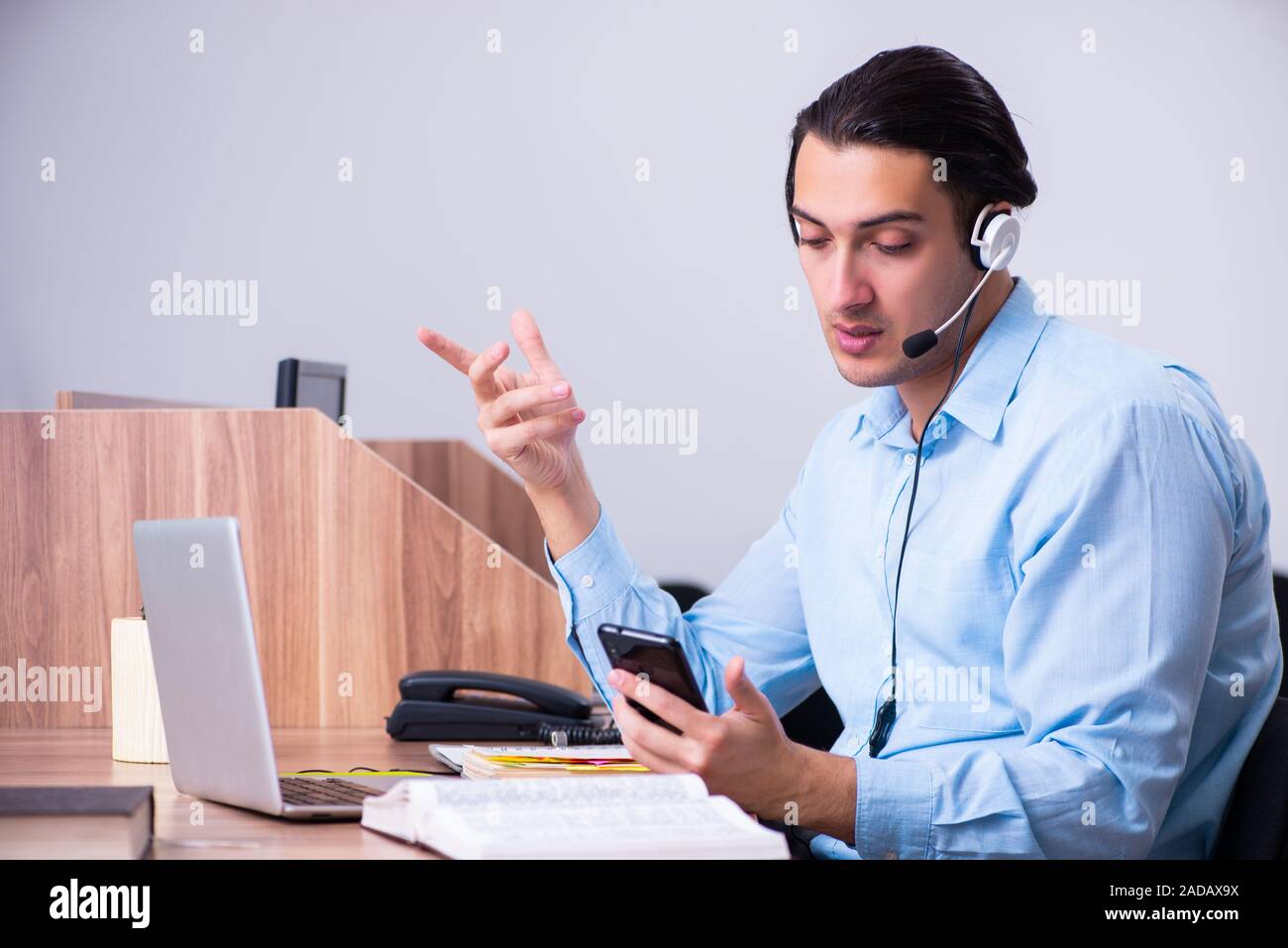 Call center operator working at his desk Stock Photo - Alamy