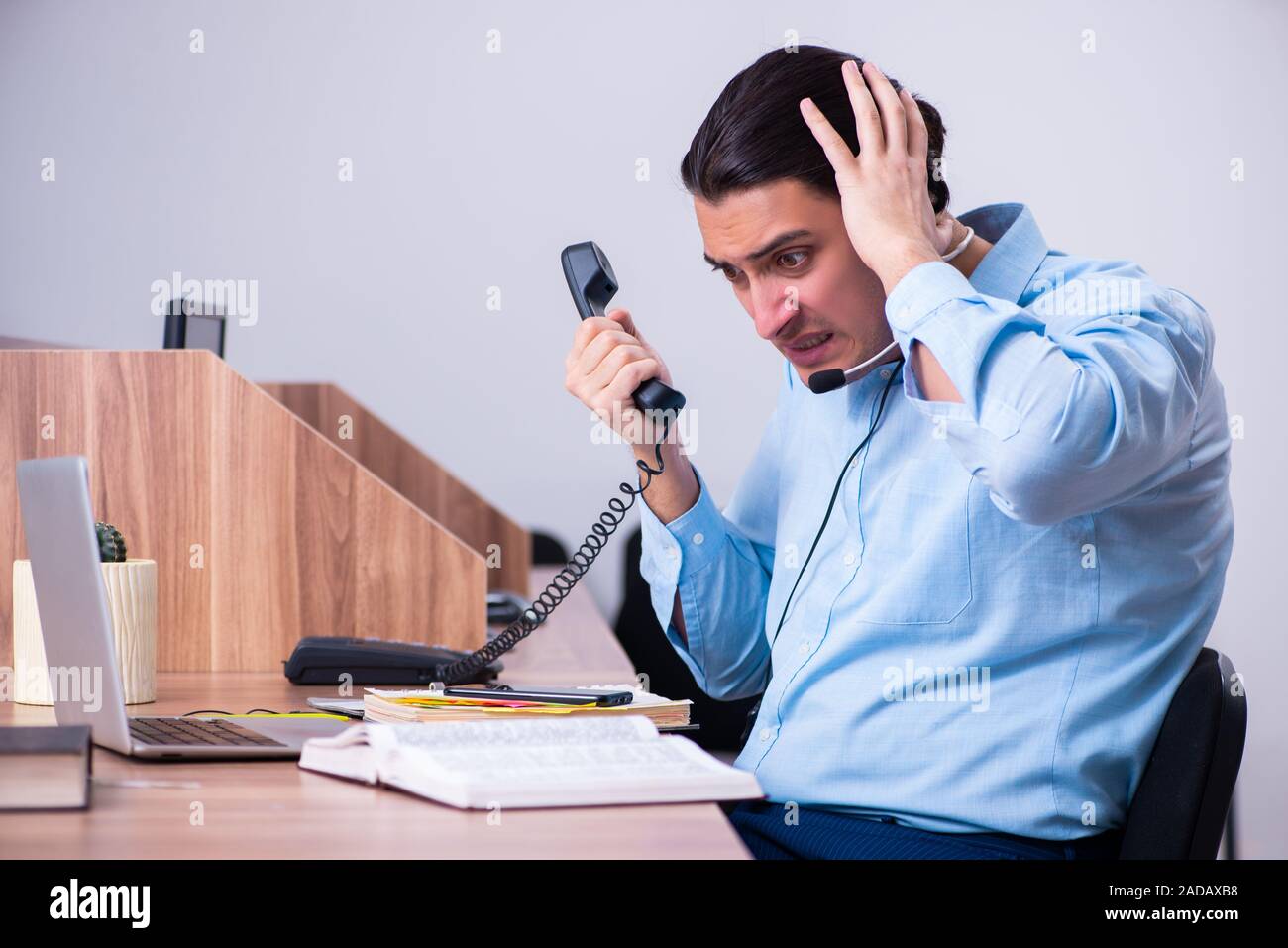 Call center operator working at his desk Stock Photo - Alamy