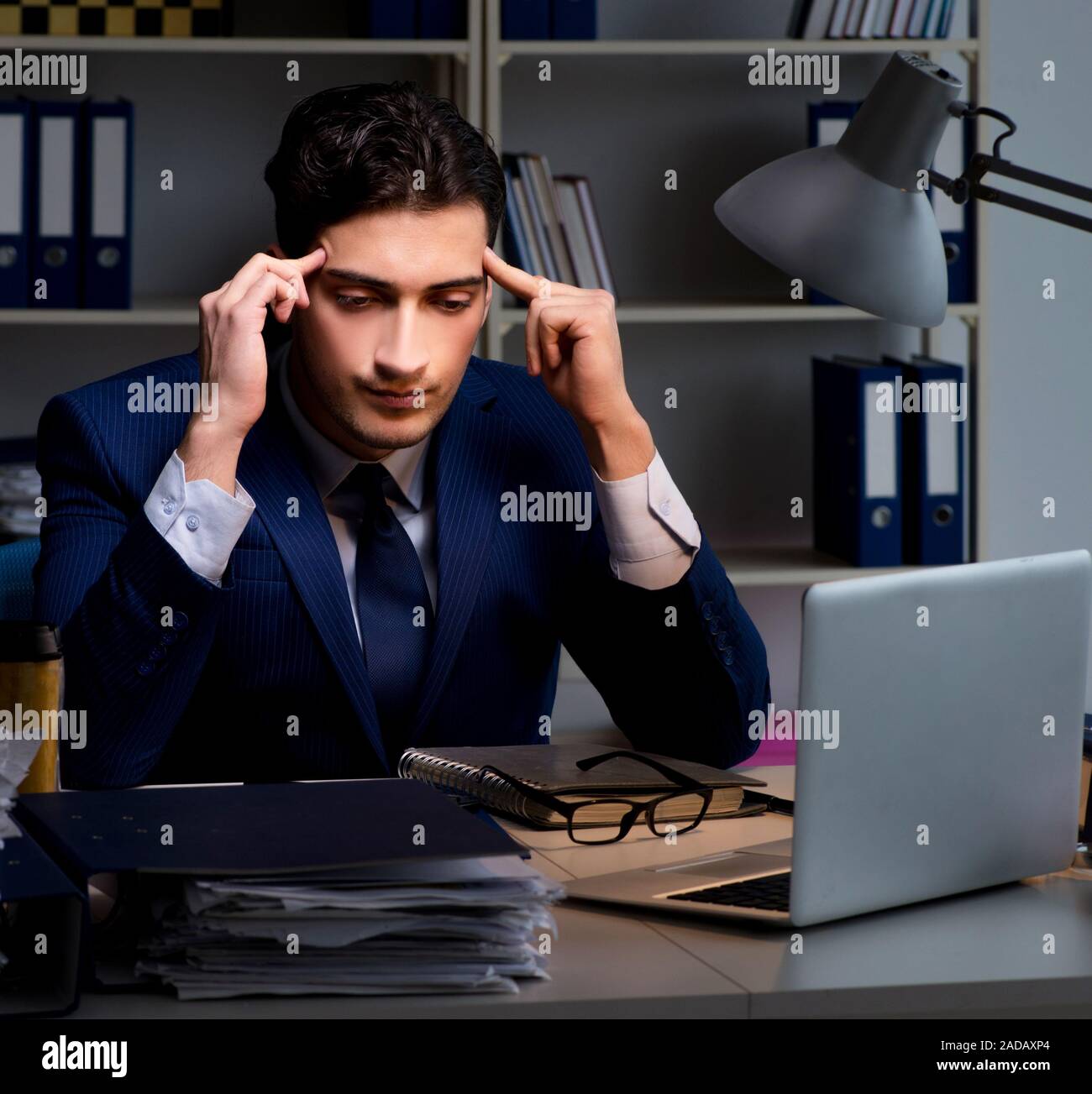 Employee working late to finish important deliverable task Stock Photo ... Employee working late to finish important deliverable task Stock Photo ...