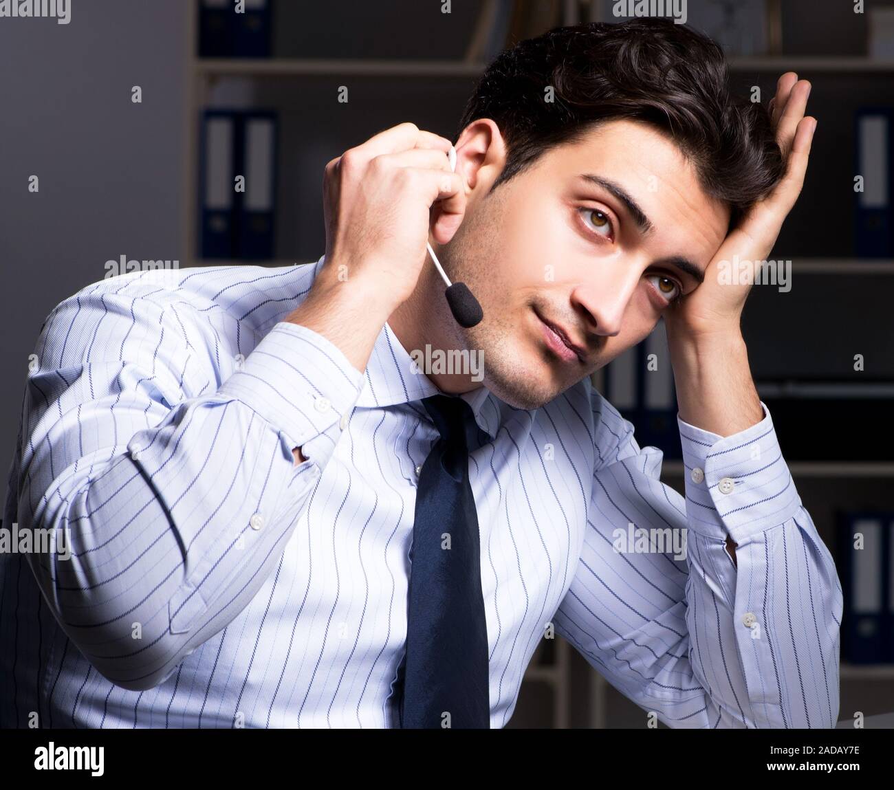 Tired and exhausted helpdesk operator during night shift Stock Photo ...