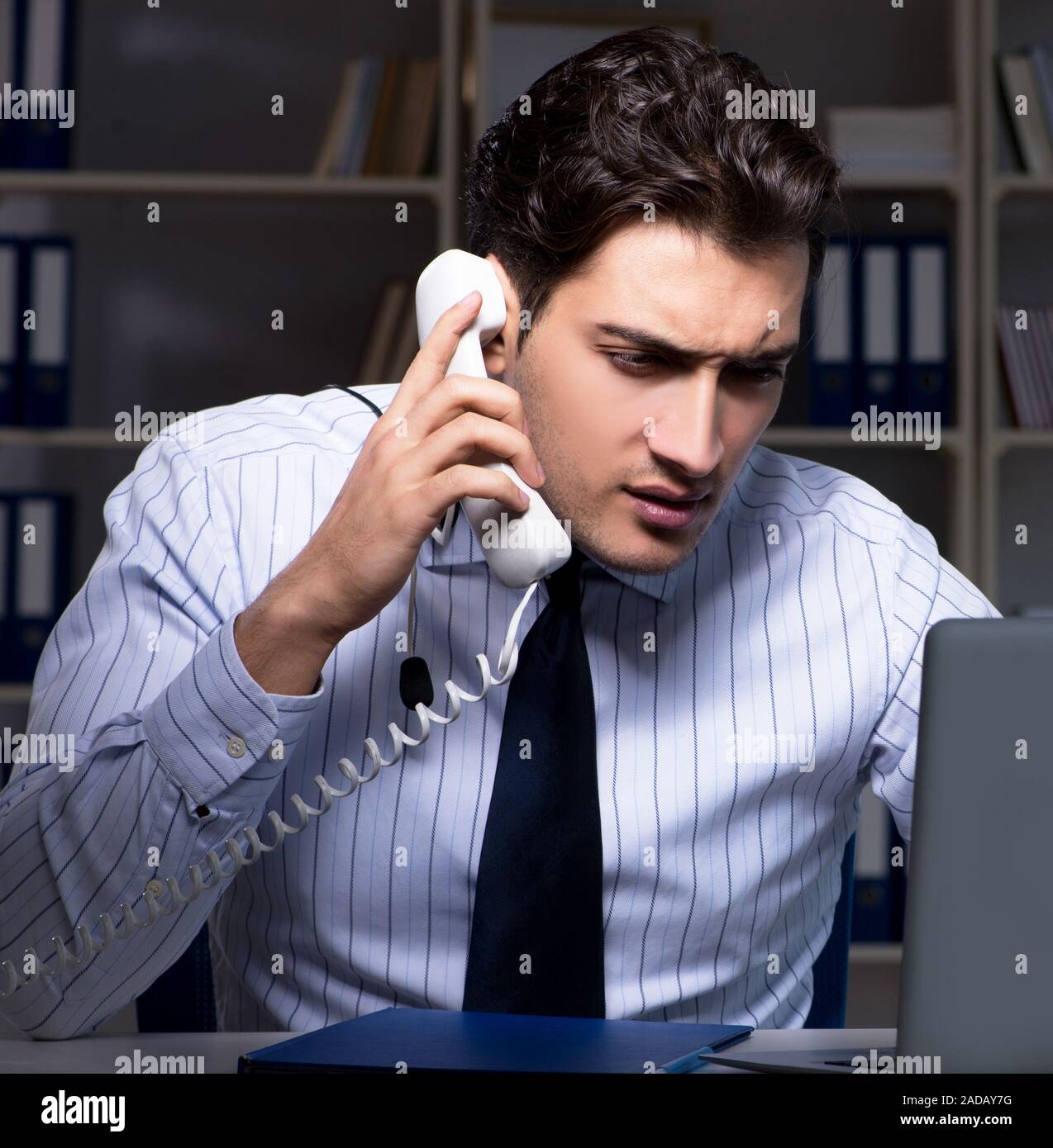 Tired and exhausted helpdesk operator during night shift Stock Photo ...