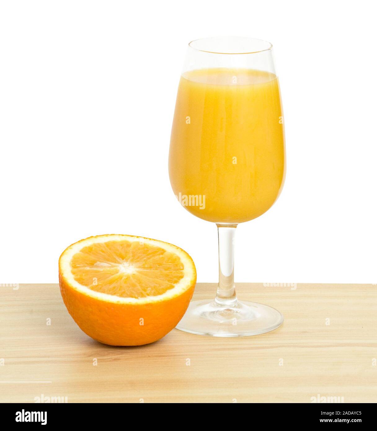Goblet of natural orange juice and section of orange Stock Photo - Alamy
