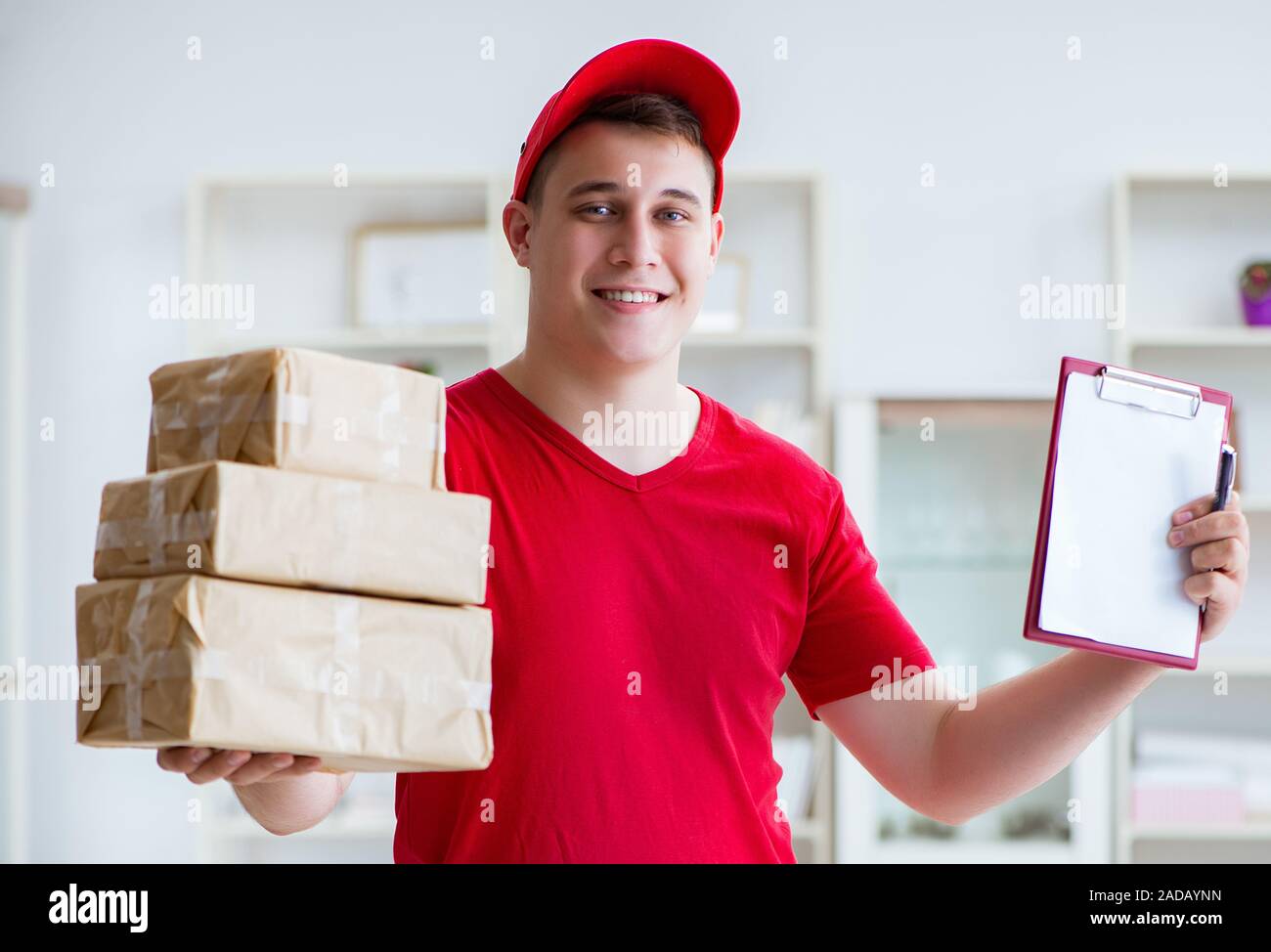 Post man delivering a parcel package Stock Photo - Alamy